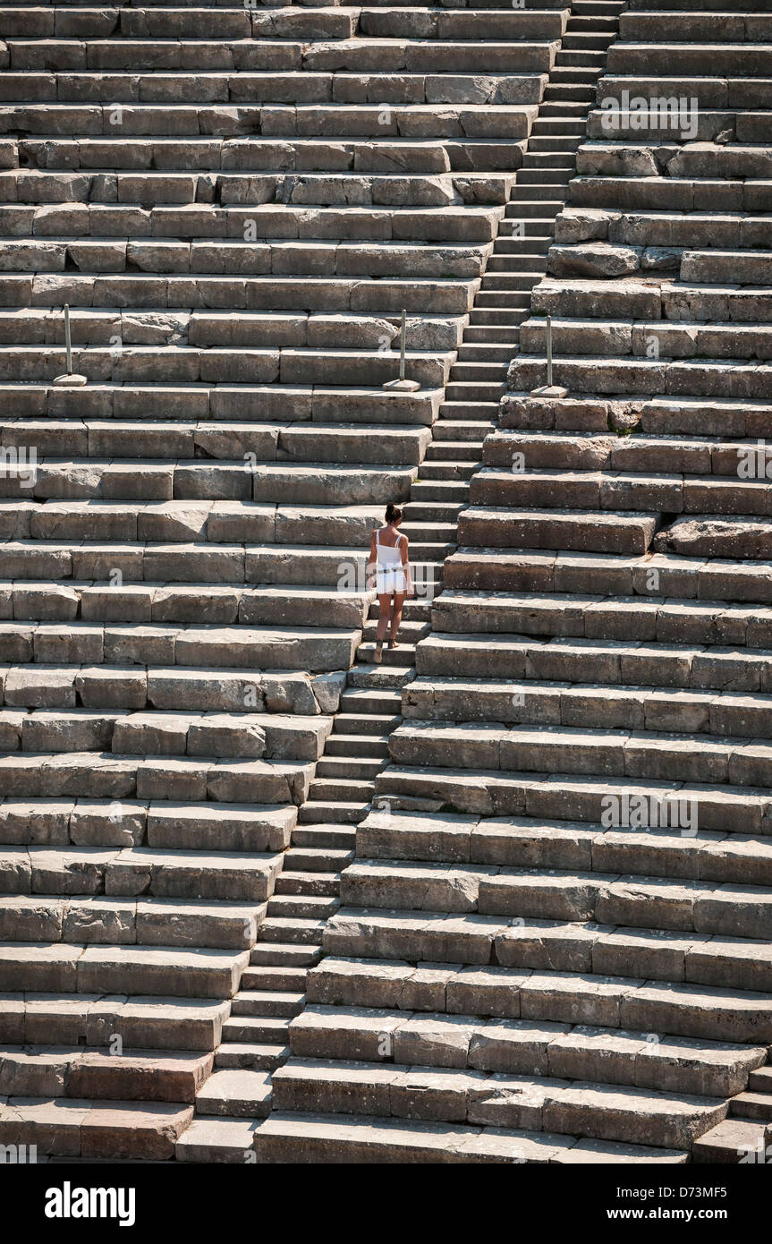 A woman ascending steps at the Classical Greek theater at Ancient ...