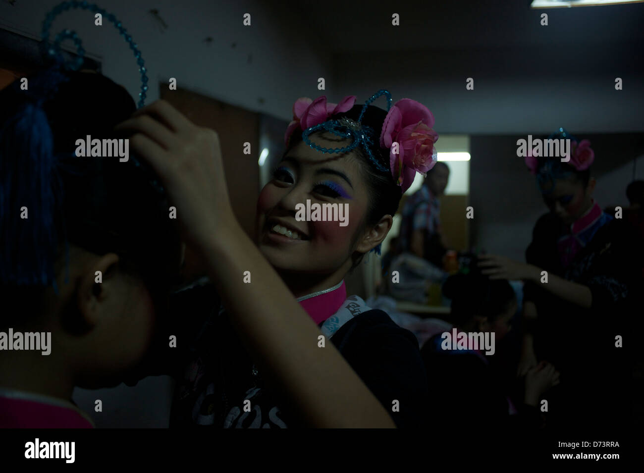 putting on a costume,helping her friend Stock Photo - Alamy