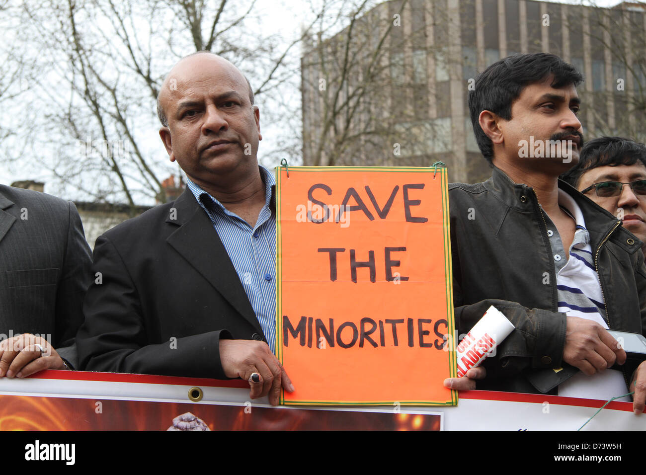 A man hold a placard with the writings "Save the Minorities". Credit ...