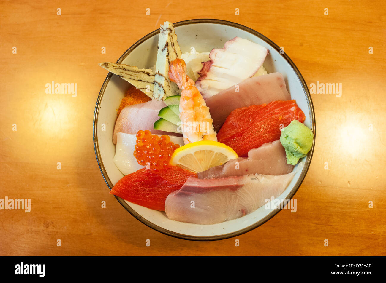 Bowl of Chirashi Sushi with fresh selection of tamago, salmon, tuna ...