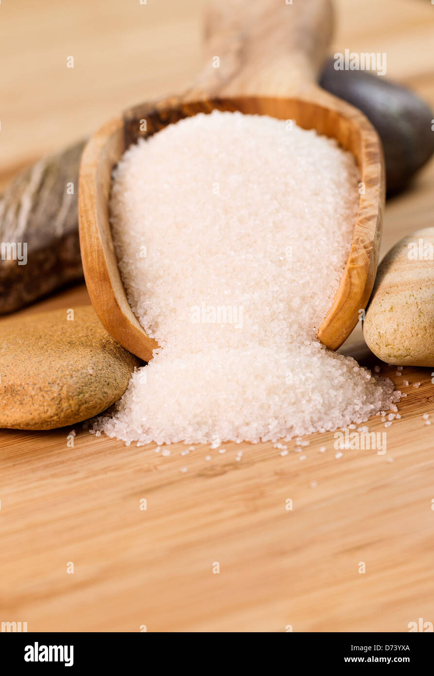 Closeup vertical photo of coarse salt on a wood surface with rough ...