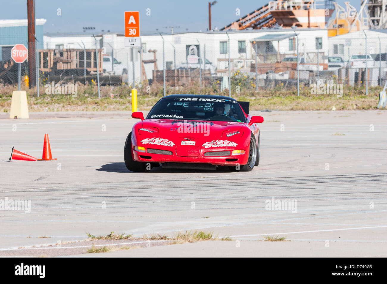 A 1997 red Chevrolet Corvette in an autocross race at a regional Sports ...