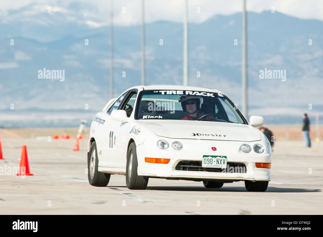 A 1992 White Acura Integra automobile in an autocross race at a ...
