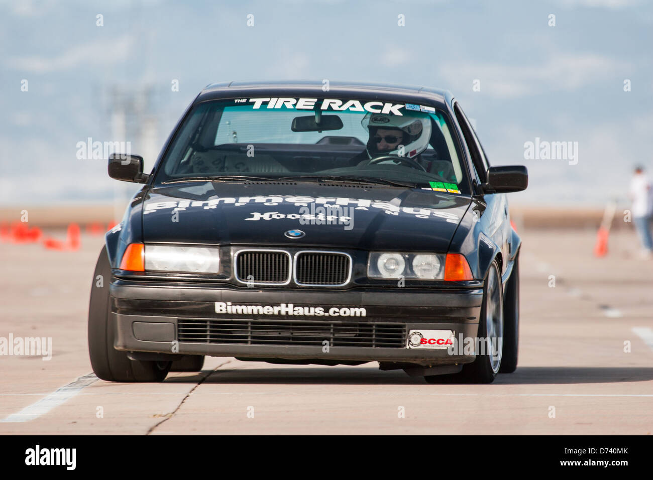 A 1995 Black BMW 325is in an autocross race at a regional Sports Car ...
