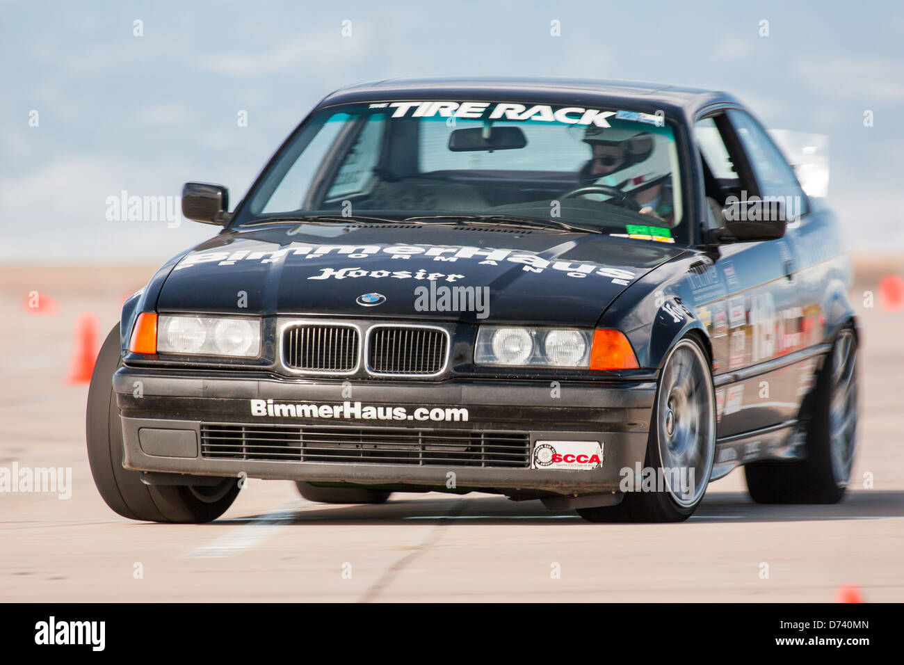 A 1995 Black BMW 325is in an autocross race at a regional Sports Car ...