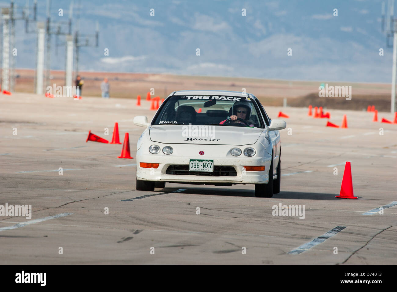 A 1992 White Acura Integra automobile in an autocross race at a ...