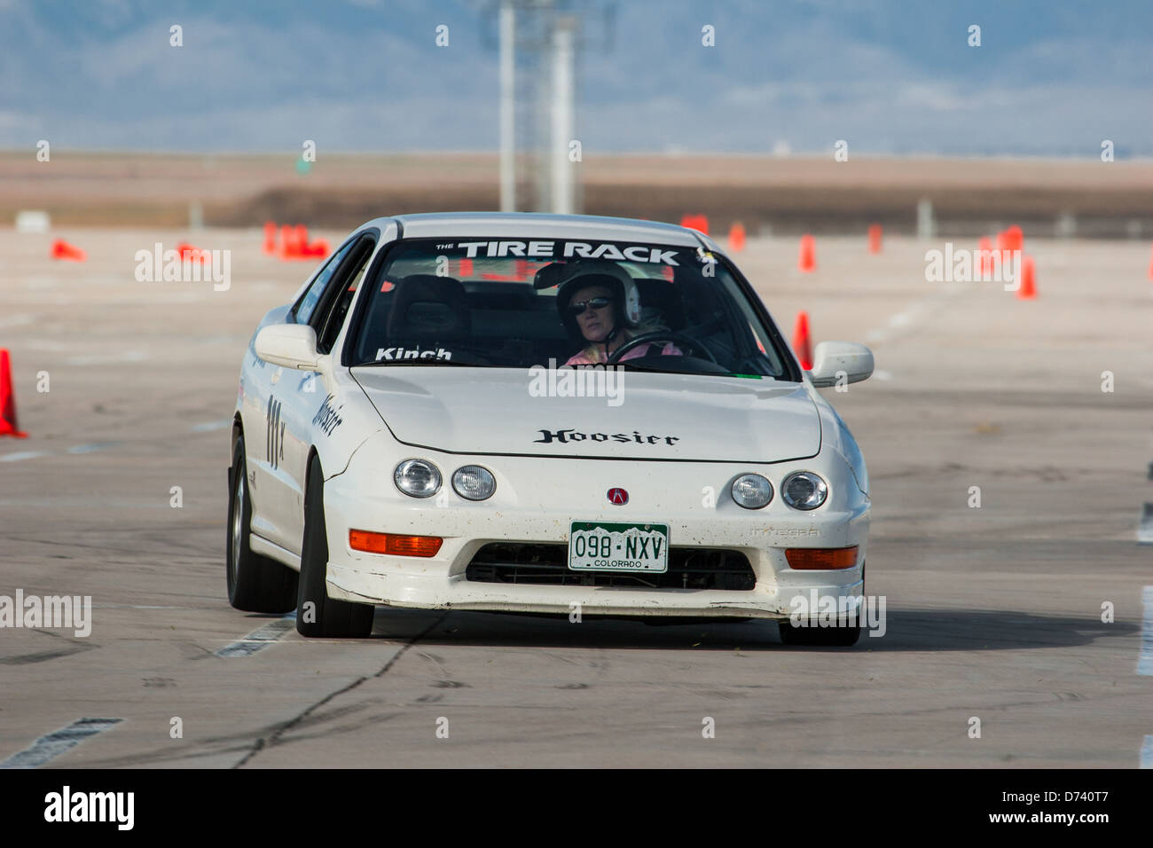 A 1992 White Acura Integra automobile in an autocross race at a ...