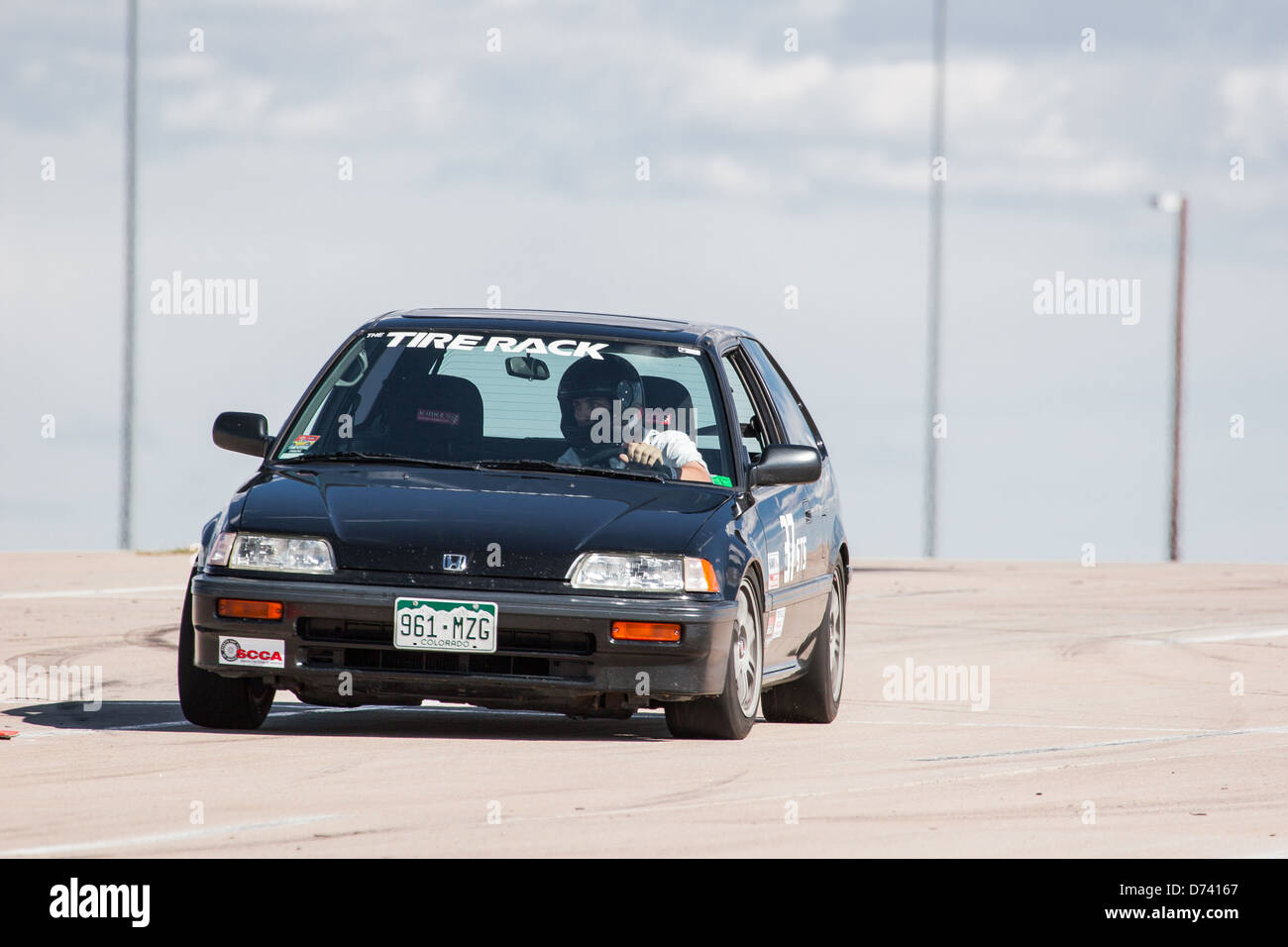 A 1989 Black Honda Civic Si automobile in an autocross race at a ...
