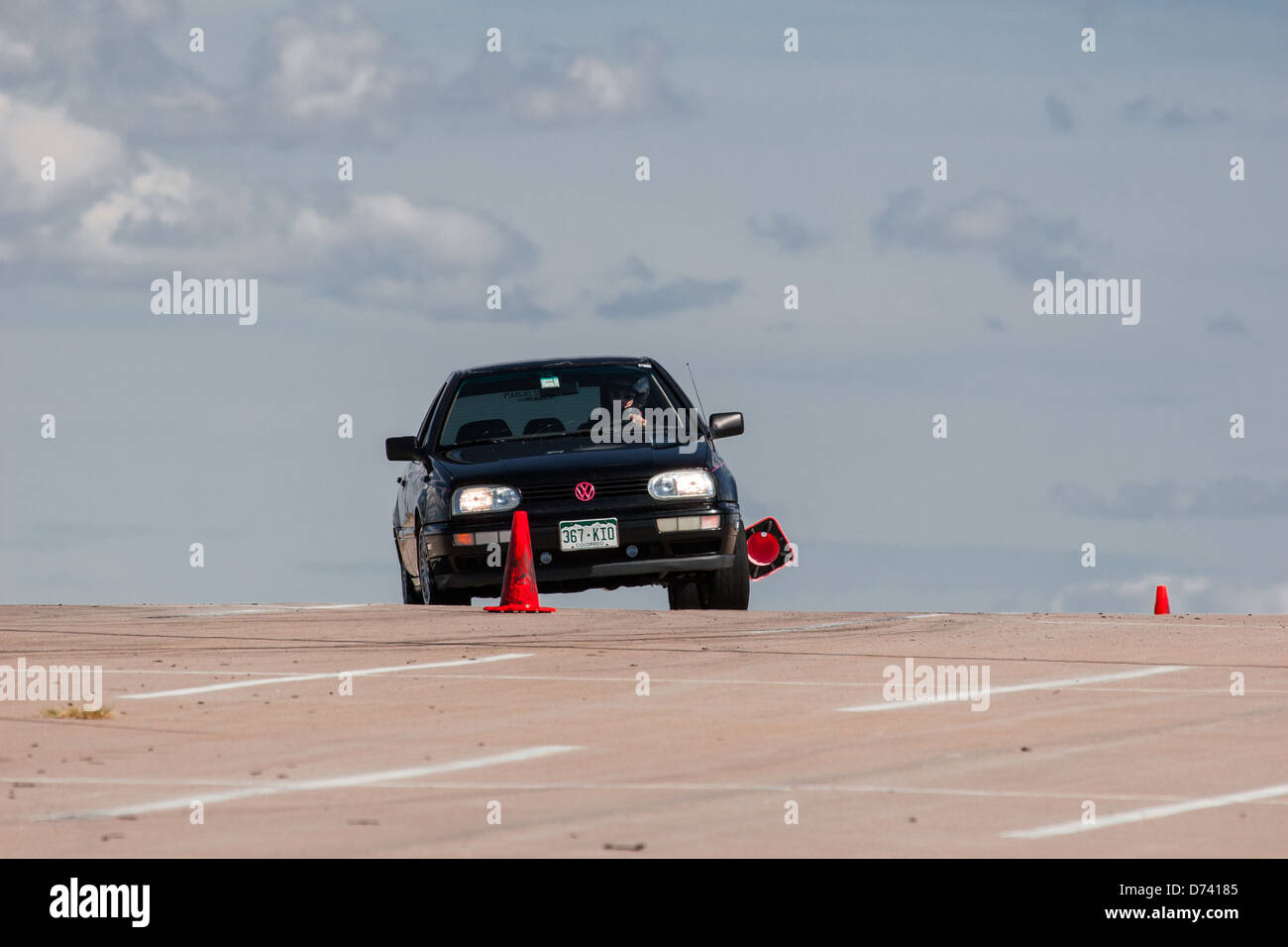 A 1995 Black Volkswagen Golf in an autocross race at a regional Sports ...