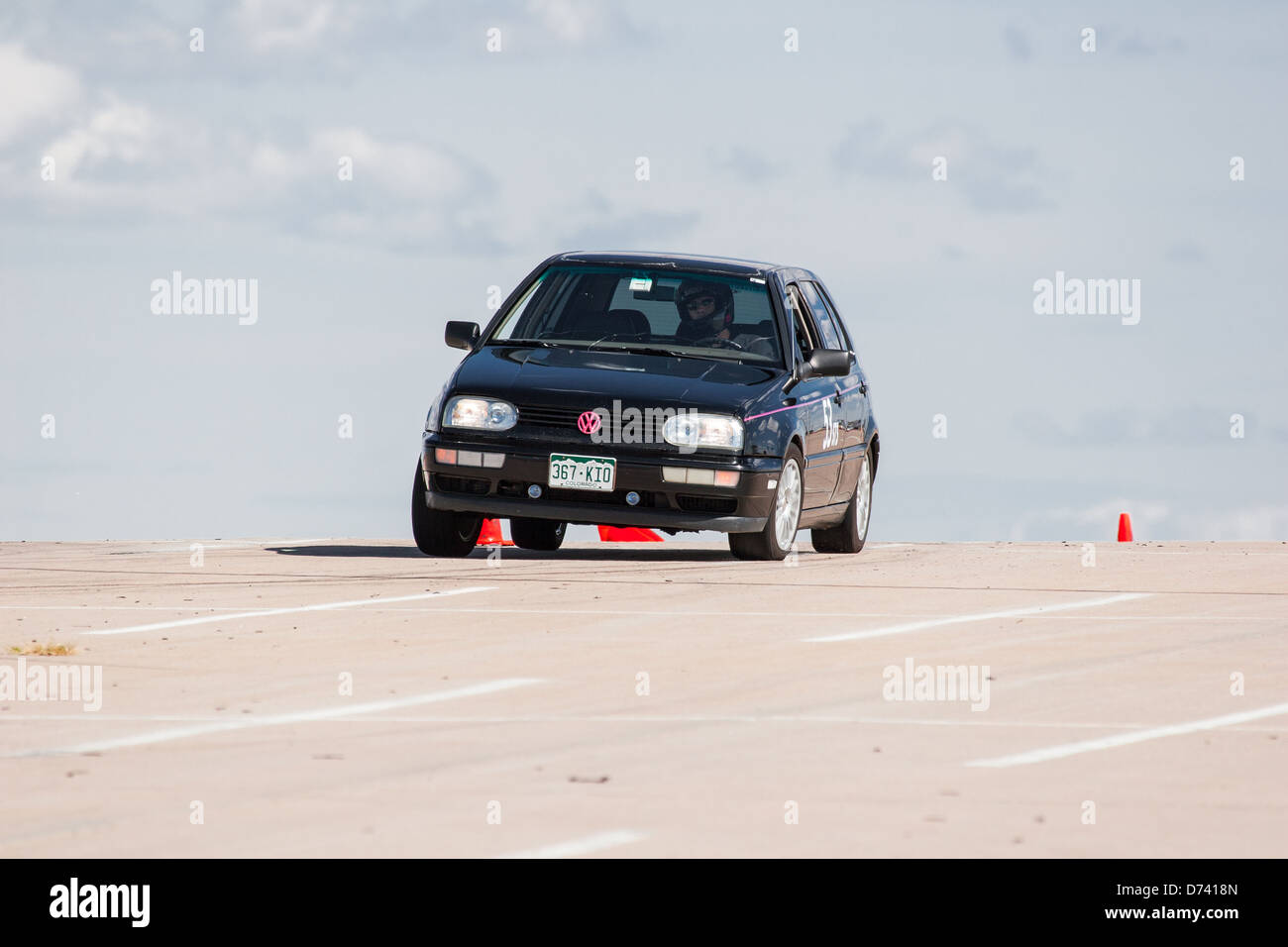 A 1995 Black Volkswagen Golf in an autocross race at a regional Sports ...