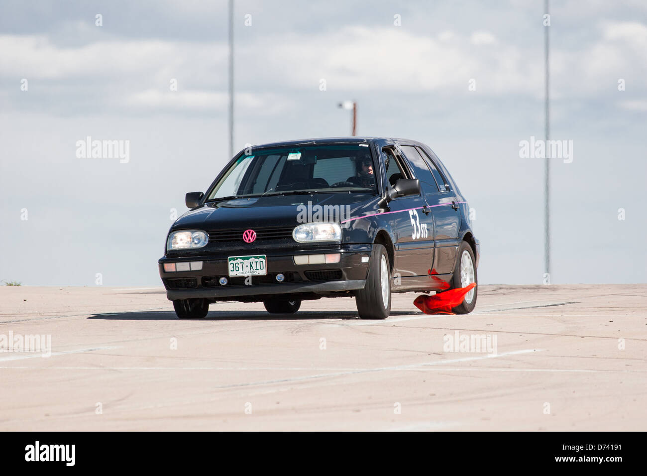 A 1995 Black Volkswagen Golf in an autocross race at a regional Sports ...