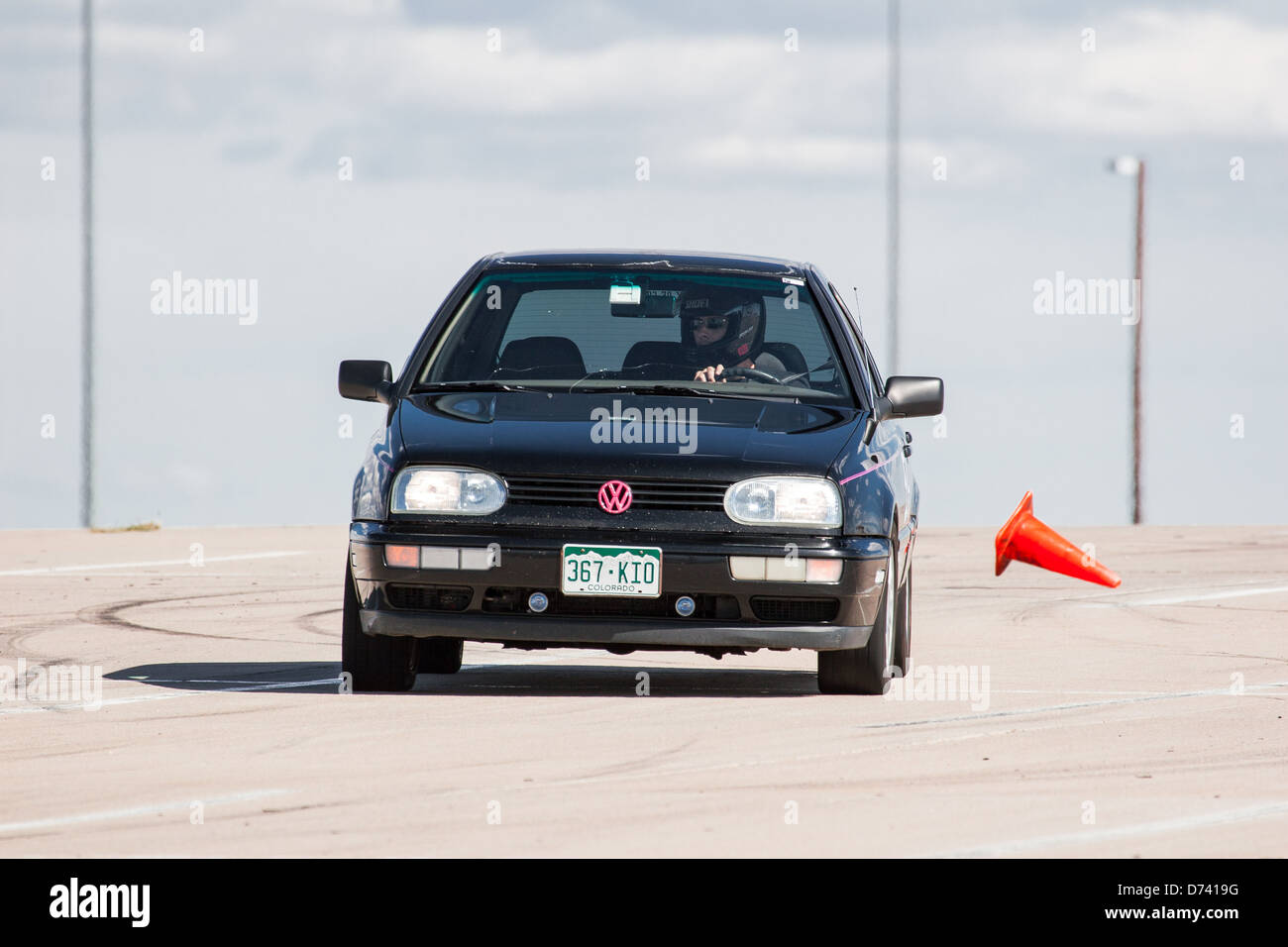 A 1995 Black Volkswagen Golf in an autocross race at a regional Sports ...