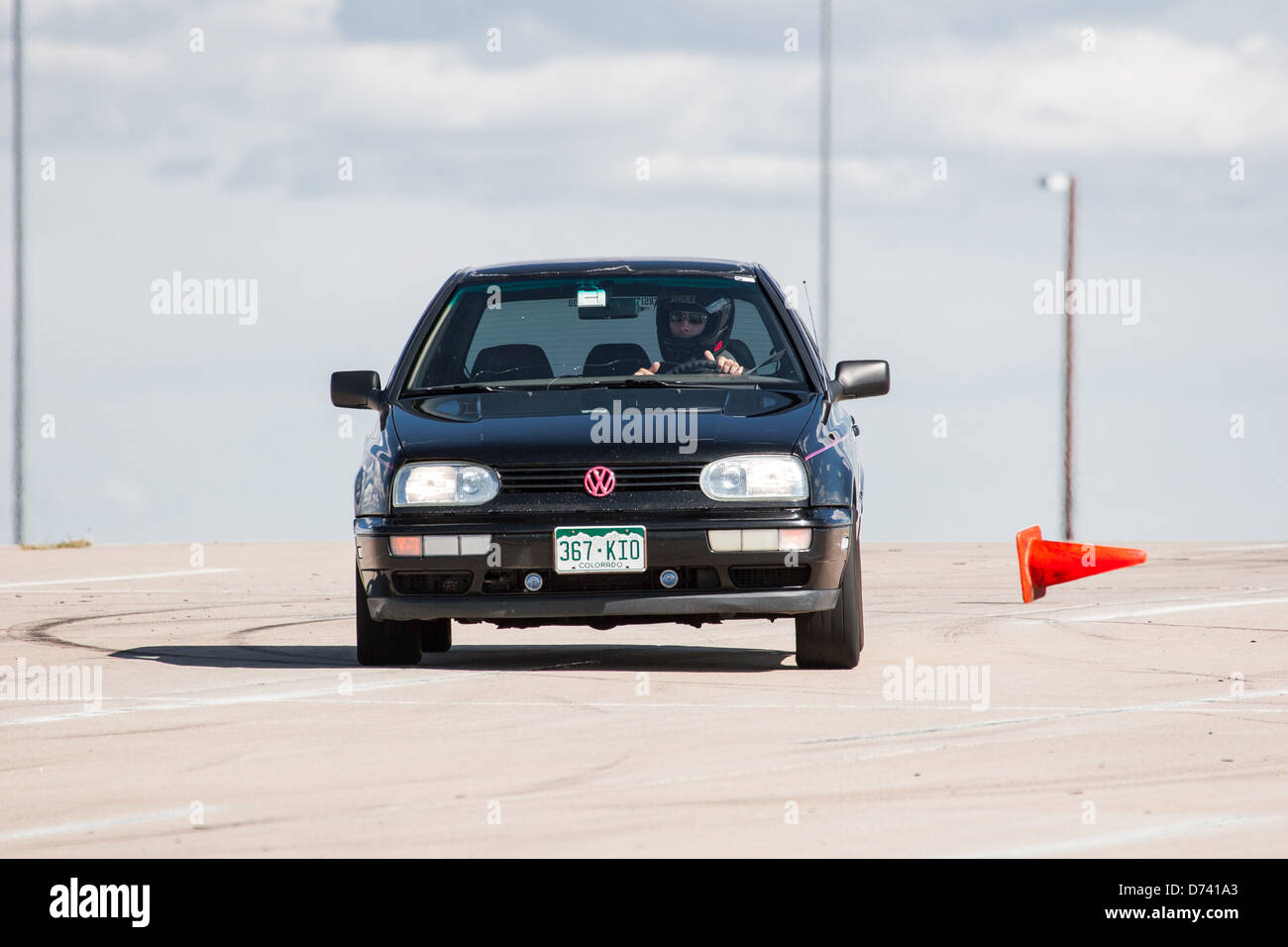 A 1995 Black Volkswagen Golf in an autocross race at a regional Sports ...