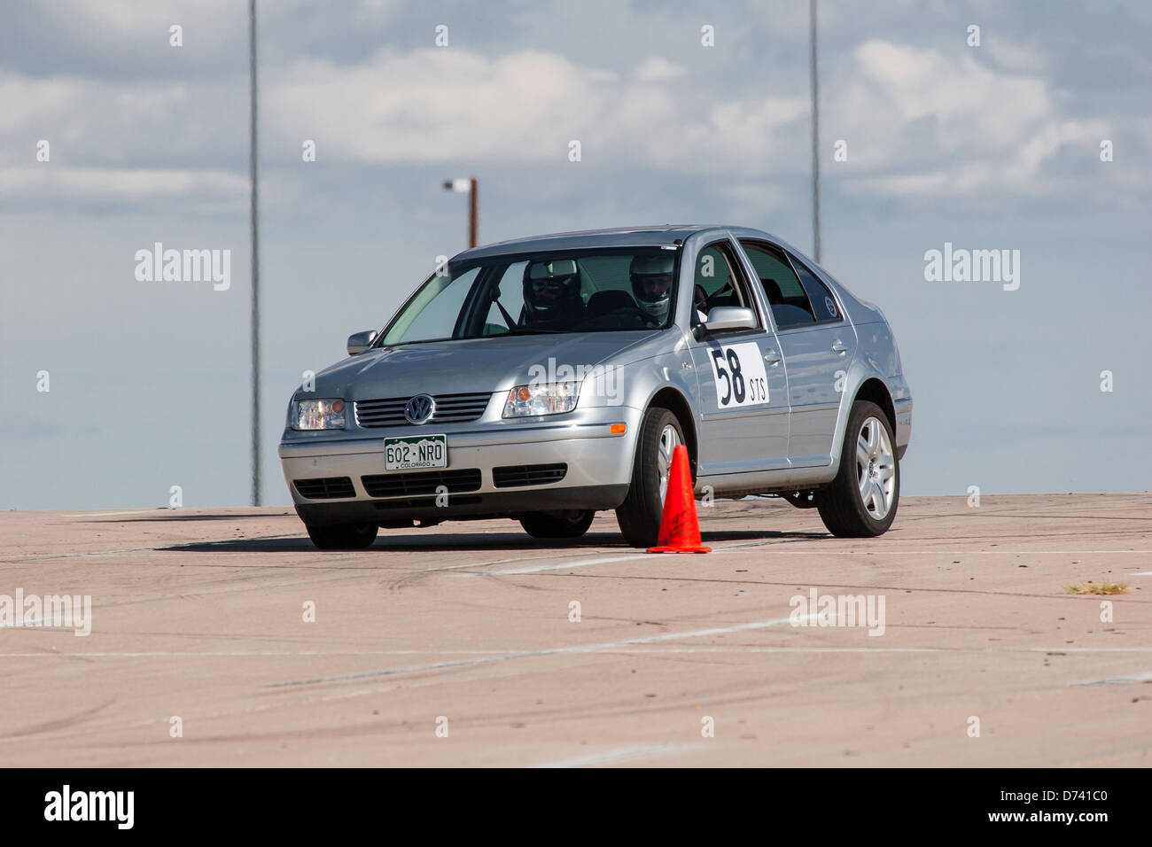 A 2004 Gray Volkswagen Jetta automobile in an autocross race at a ...