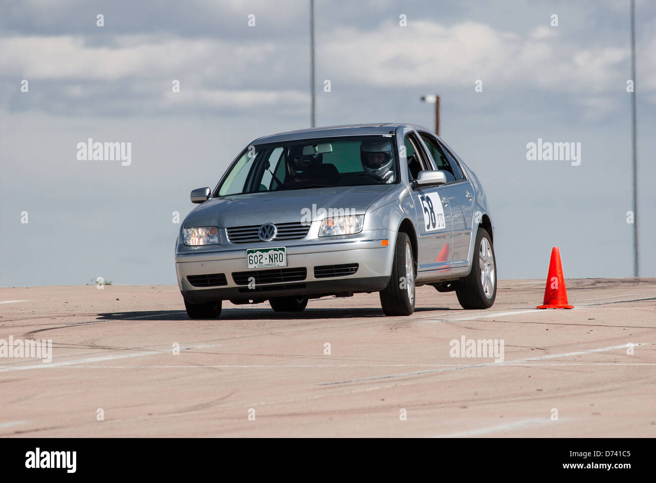 A 2004 Gray Volkswagen Jetta automobile in an autocross race at a ...