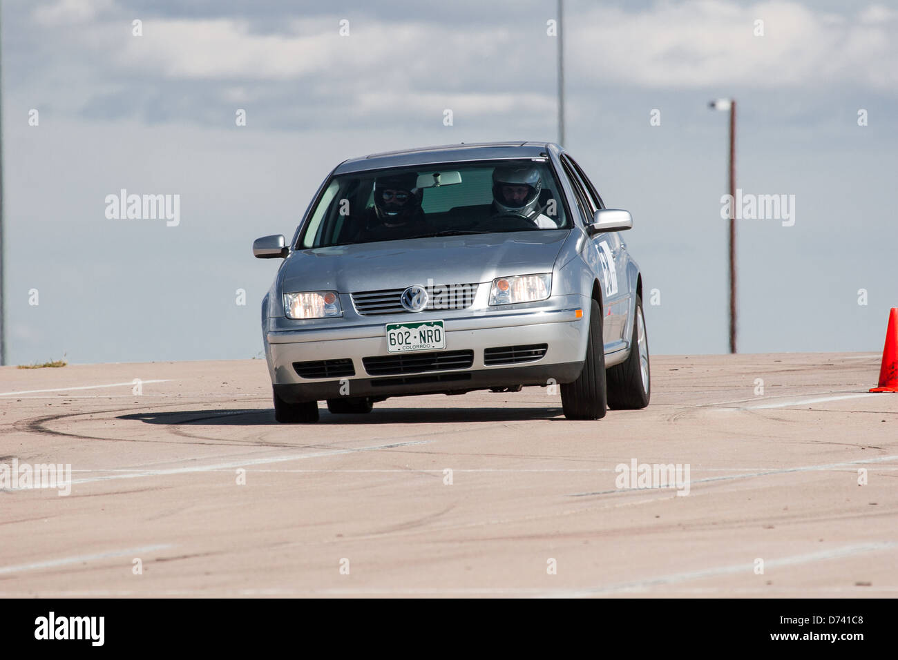 A 2004 Gray Volkswagen Jetta automobile in an autocross race at a ...