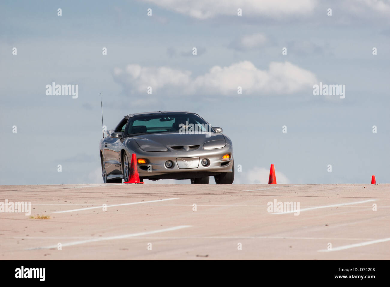 A 2001 Gray Pontiac Trans Am automobile in an autocross race at a ...