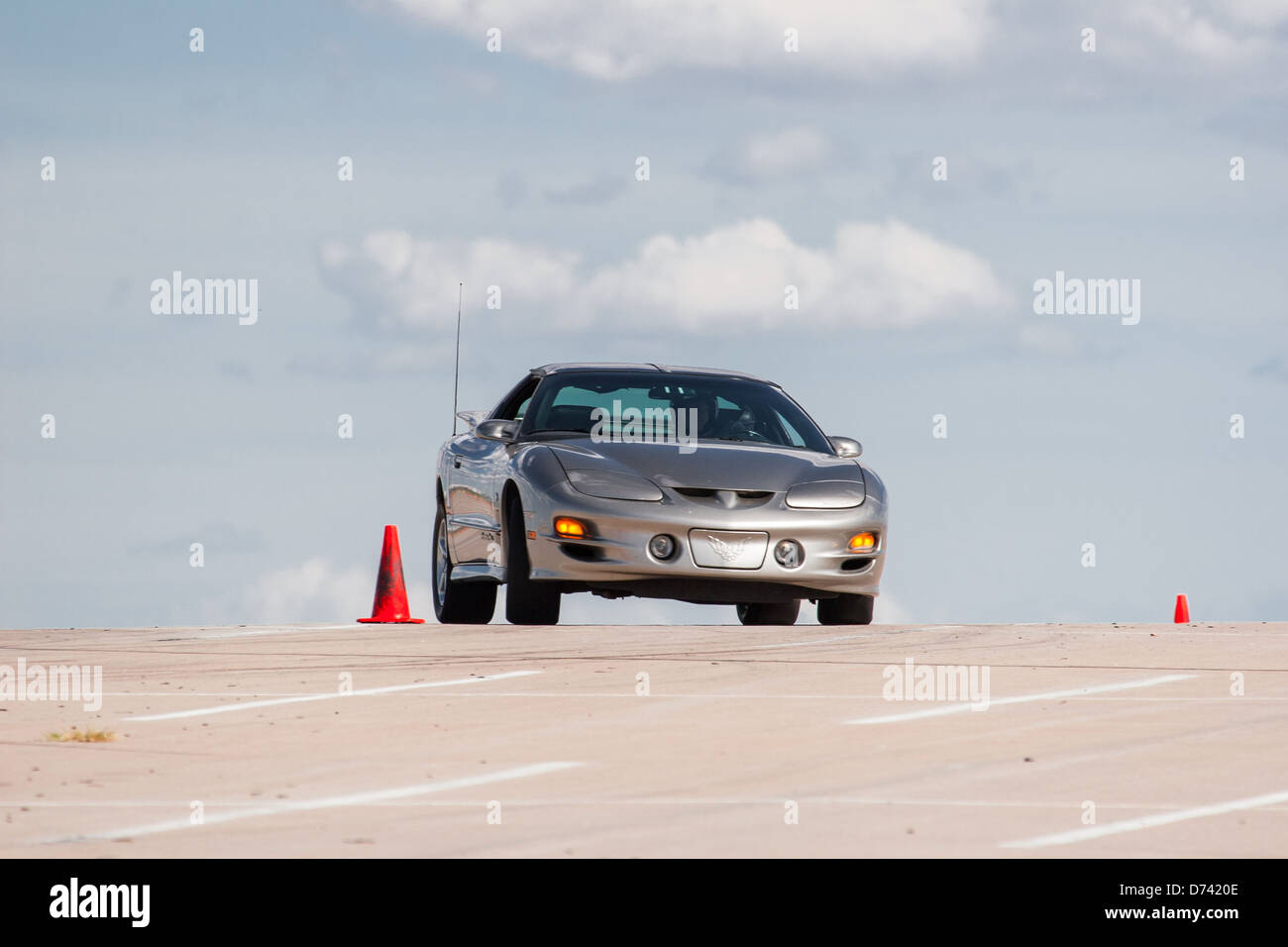 A 2001 Gray Pontiac Trans Am automobile in an autocross race at a ...