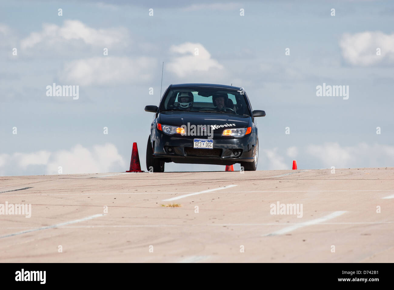 A 2006 Black Saturn Ion Redline automobile in an autocross race at a ...