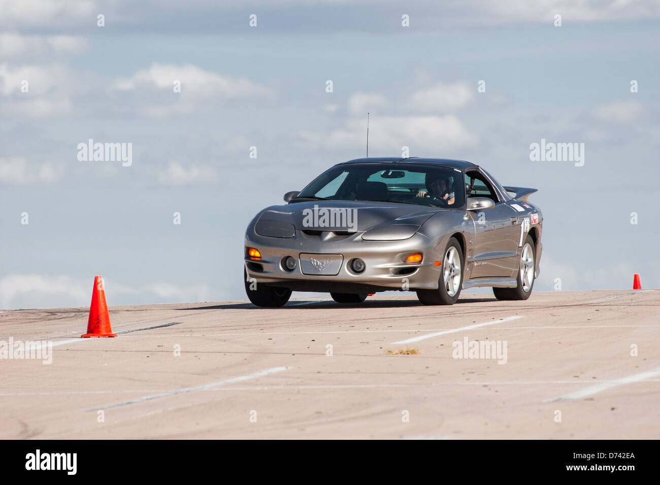 A 2001 Gray Pontiac Trans Am automobile in an autocross race at a ...