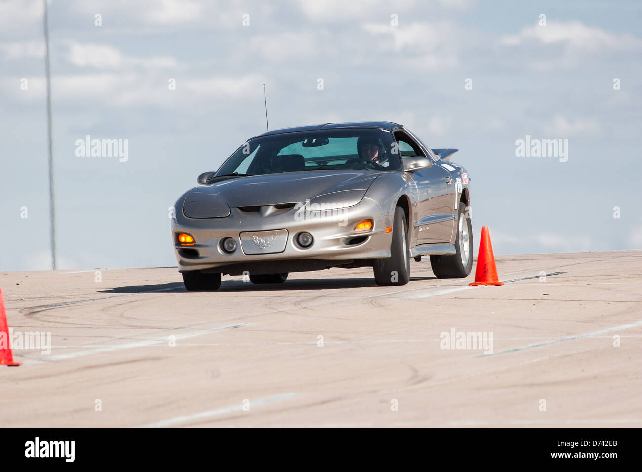 A 2001 Gray Pontiac Trans Am automobile in an autocross race at a ...