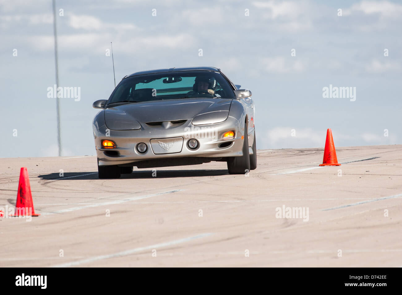 A 2001 Gray Pontiac Trans Am automobile in an autocross race at a ...