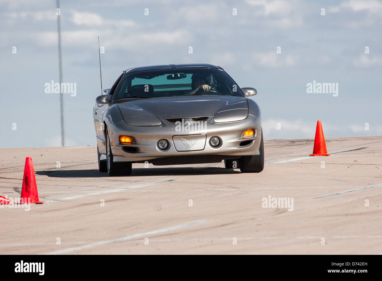 A 2001 Gray Pontiac Trans Am automobile in an autocross race at a ...