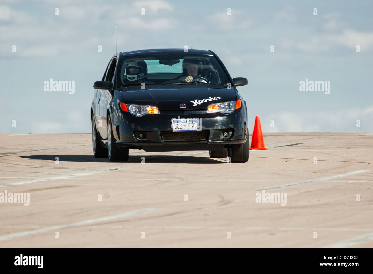 A 2006 Black Saturn Ion Redline automobile in an autocross race at a ...