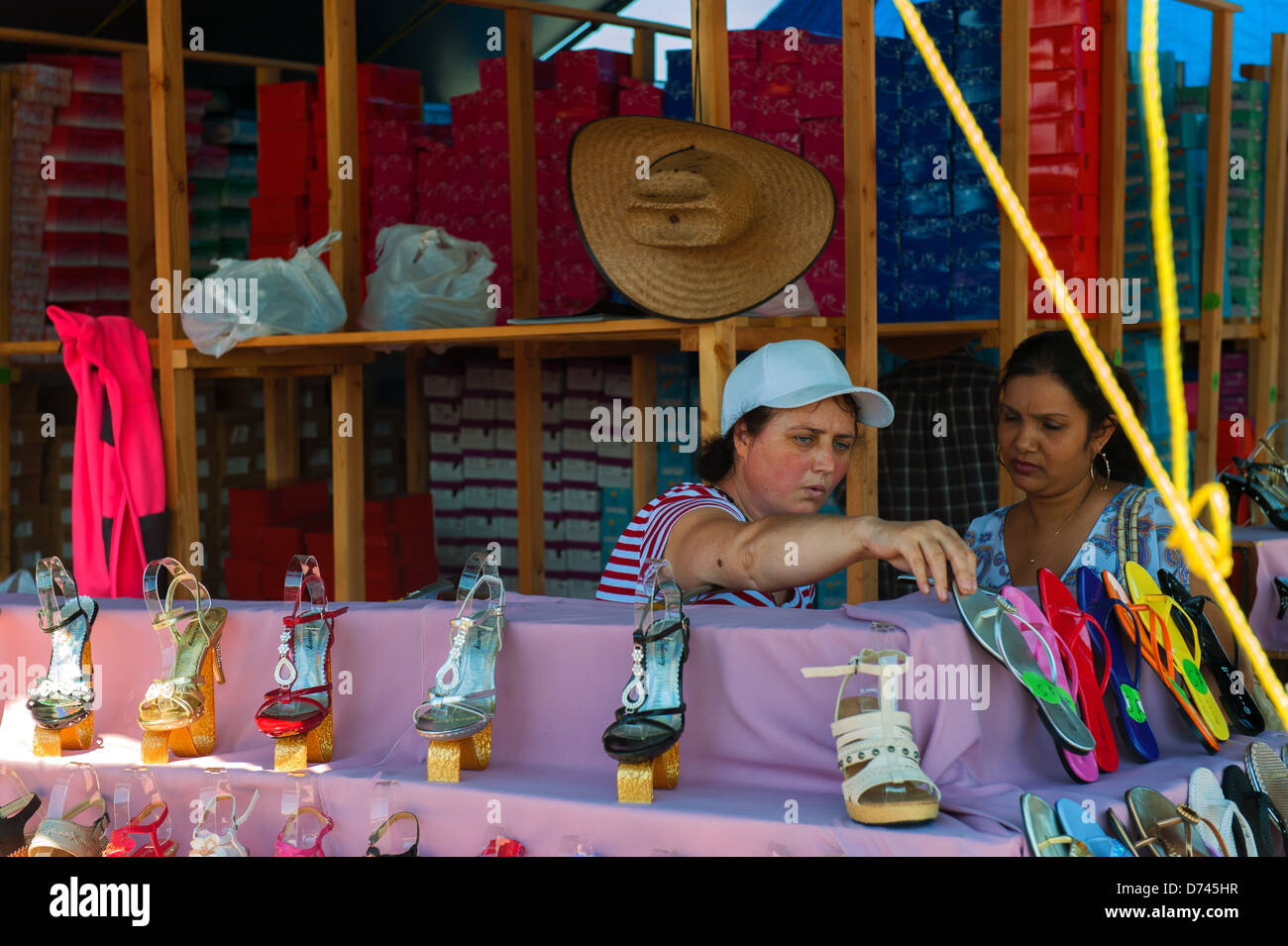 A shoe vendor and a buyer at the Davis swap meet market Stock Photo - Alamy