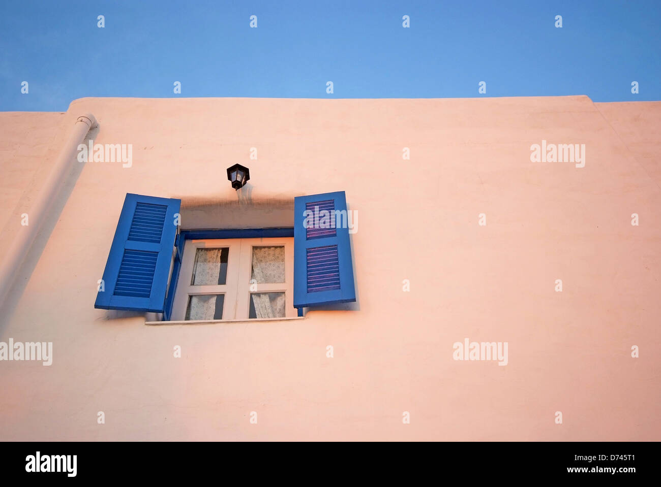 Vintage blue windows on the white wall and blue sky Stock Photo - Alamy