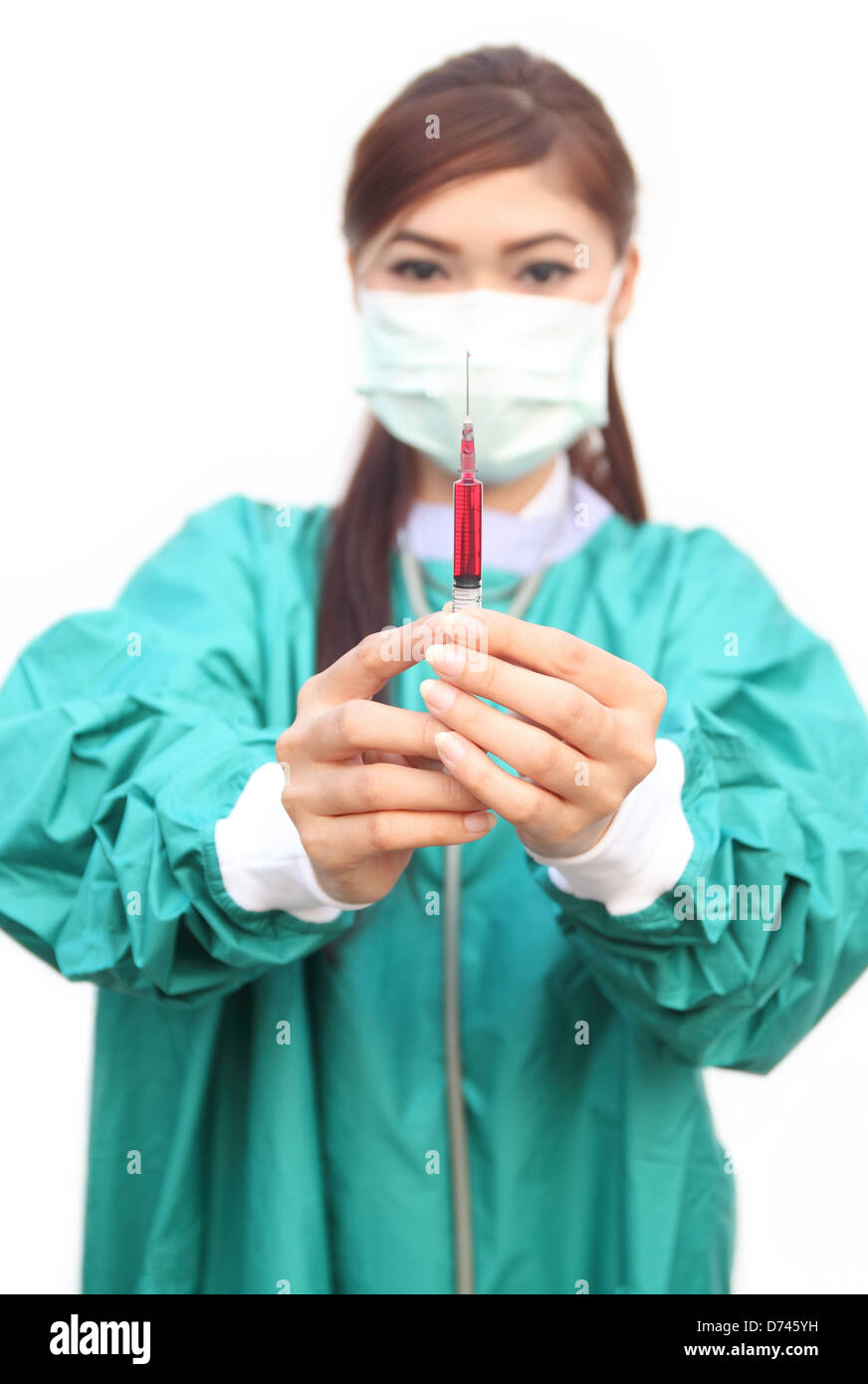 female doctor wearing a green scrubs with syringe Stock Photo - Alamy