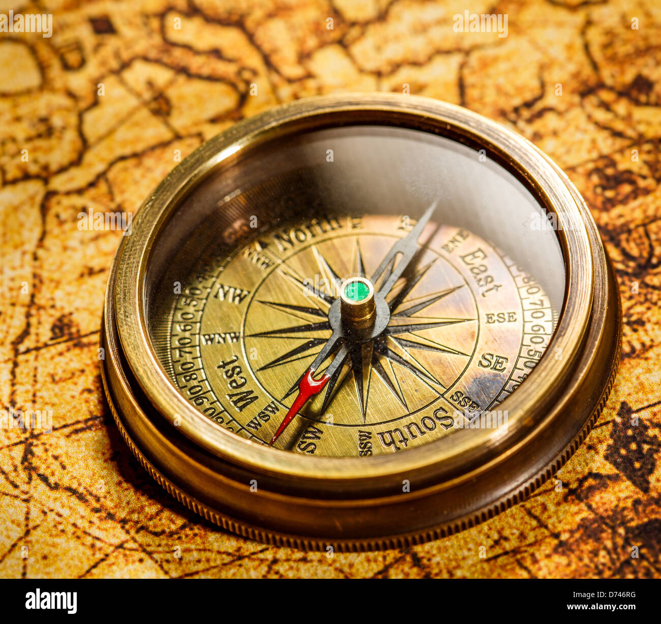 Vintage still life. Vintage compass lies on an ancient world map Stock ...