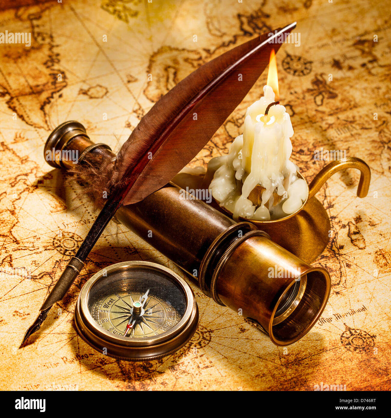 Vintage compass, quill pen, spyglass lie on an old ancient map with a ...