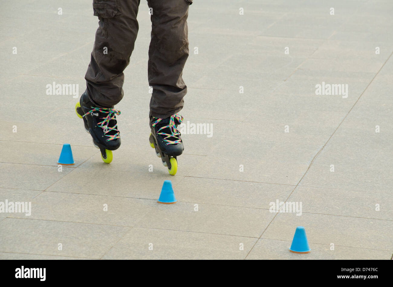 Roller skater practicing slalom along a line of cones Stock Photo - Alamy