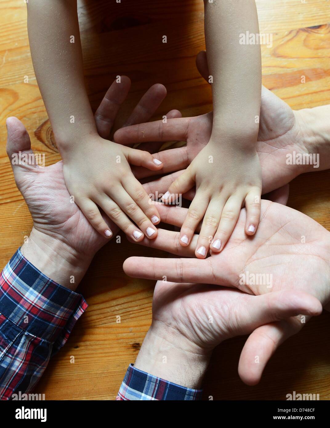 Hands of a homosexual couple and a child are pictured in Berlin ...