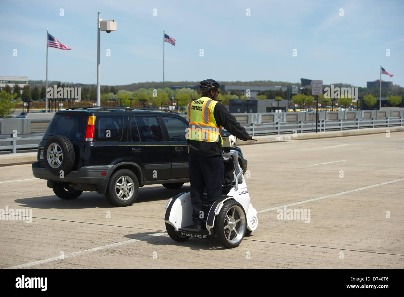 A police officer checks vehicles, while moving on a Segway, at the ...