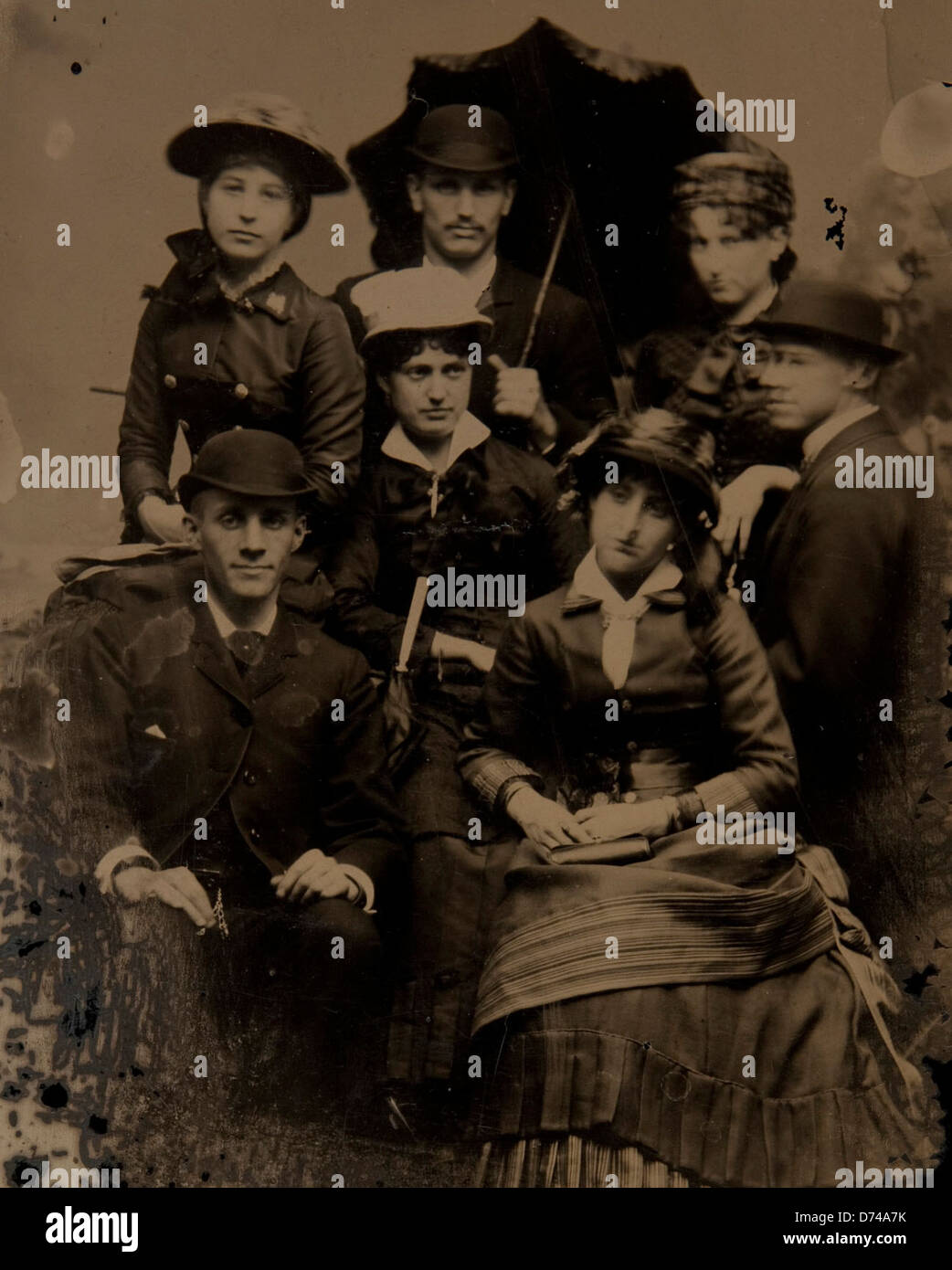This 1860 group portrait features seven people with an umbrella ...