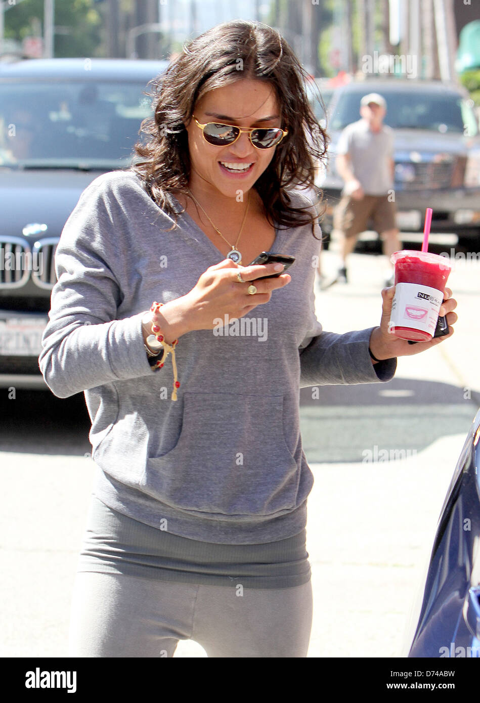 Michelle Rodriguez checking her cell phone as she leaves a smoothie ...