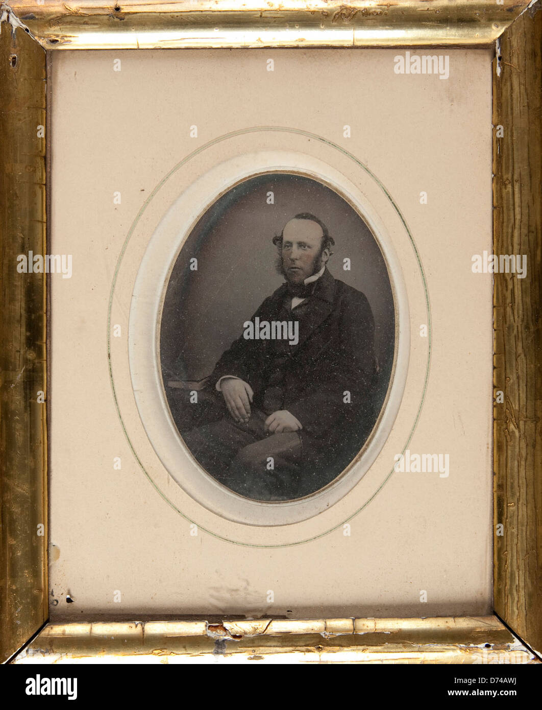 An 1865 ambrotype portrait of a man, featuring an oval frame. The ...