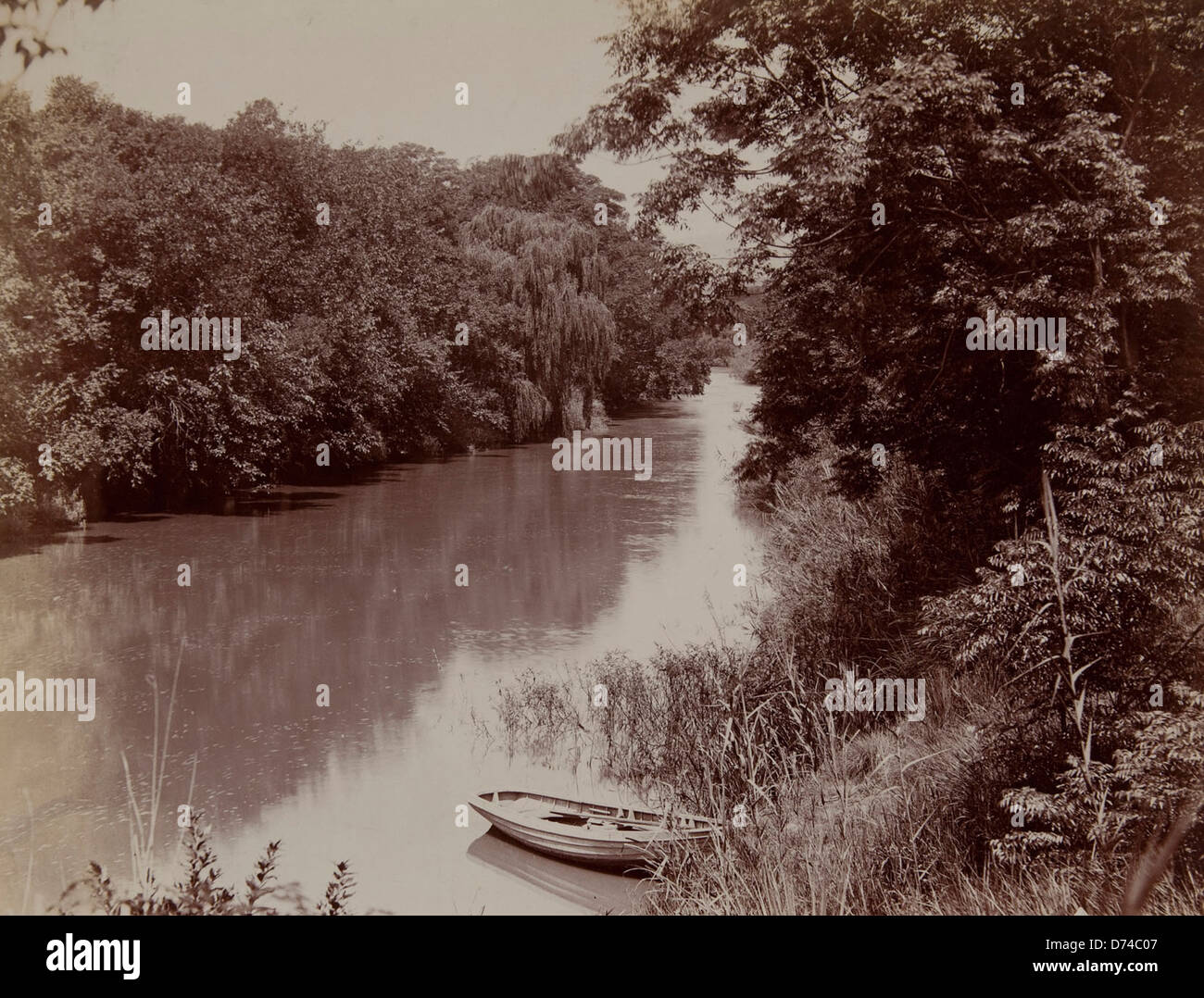 A serene image of a rowboat drifting along a quiet stream, capturing ...