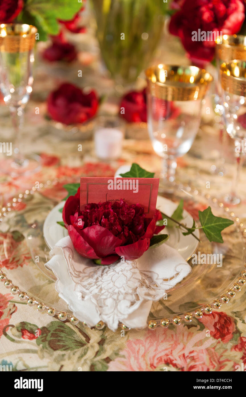 Fancy table setting with red flowers Stock Photo - Alamy