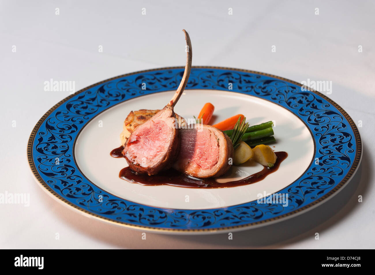 Dinner plate of rare lamb chops Stock Photo - Alamy