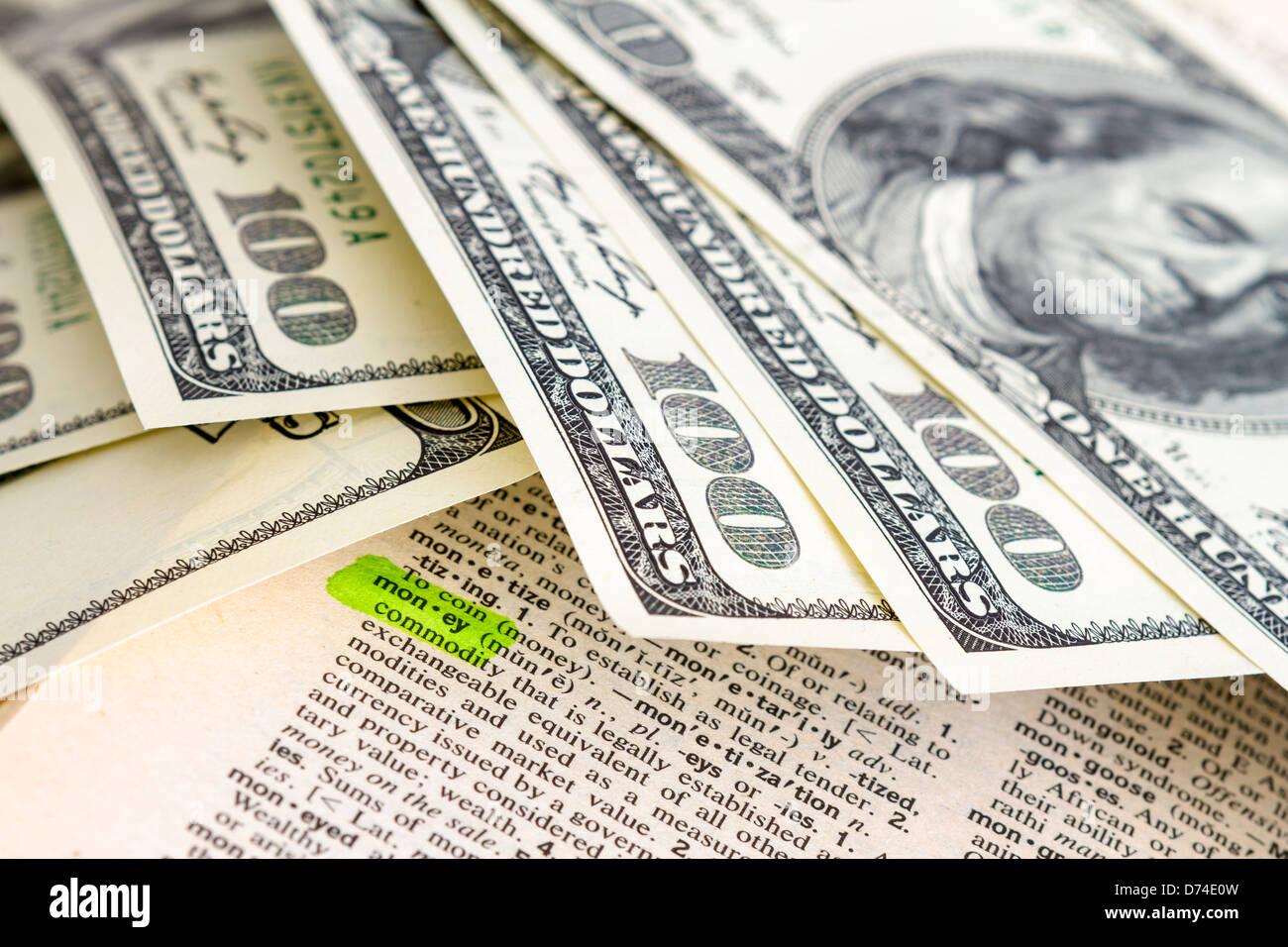 The word money in dictionary with dollars Stock Photo - Alamy
