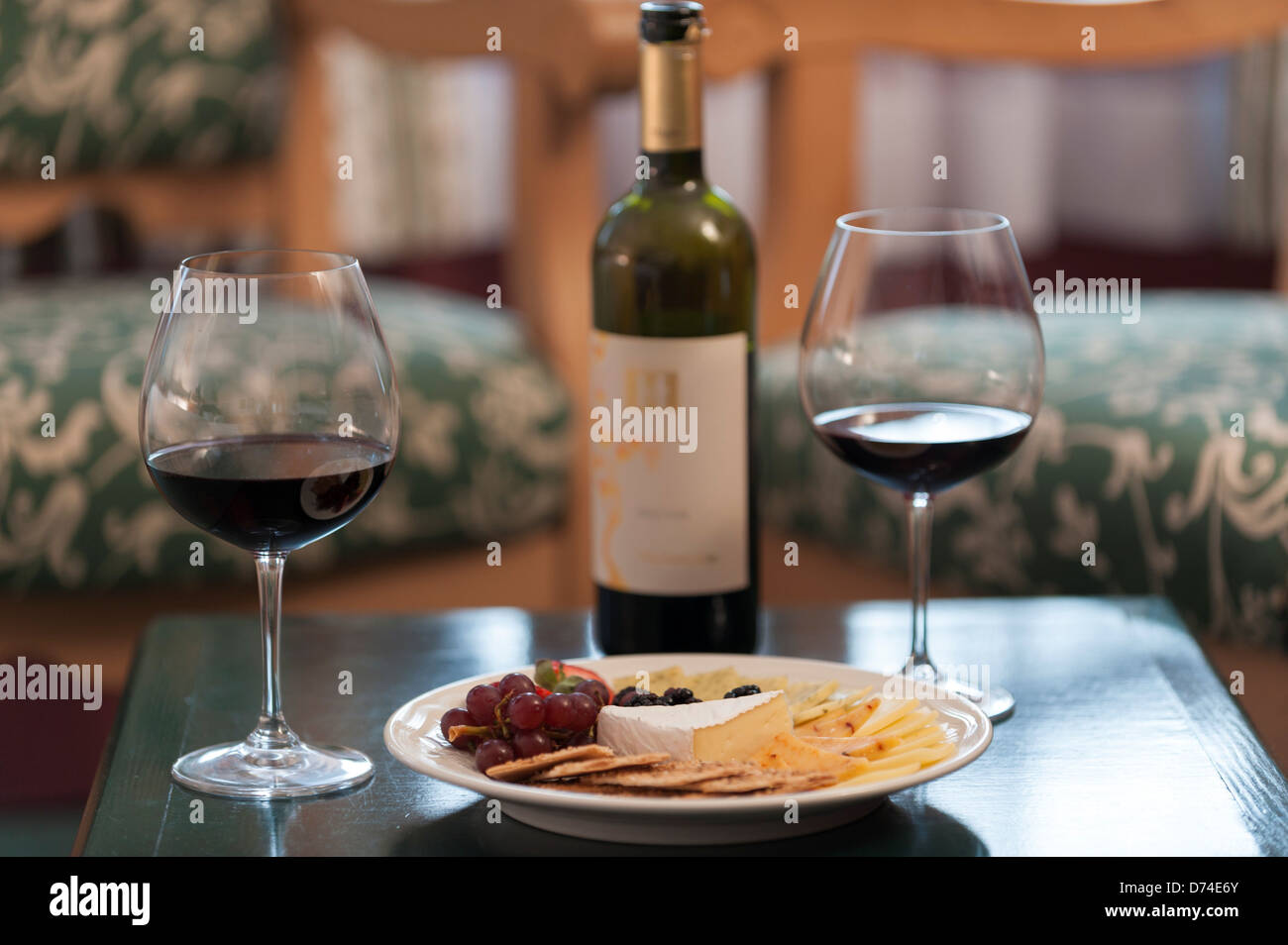 Two glasses of red wine and cheese platter Stock Photo - Alamy