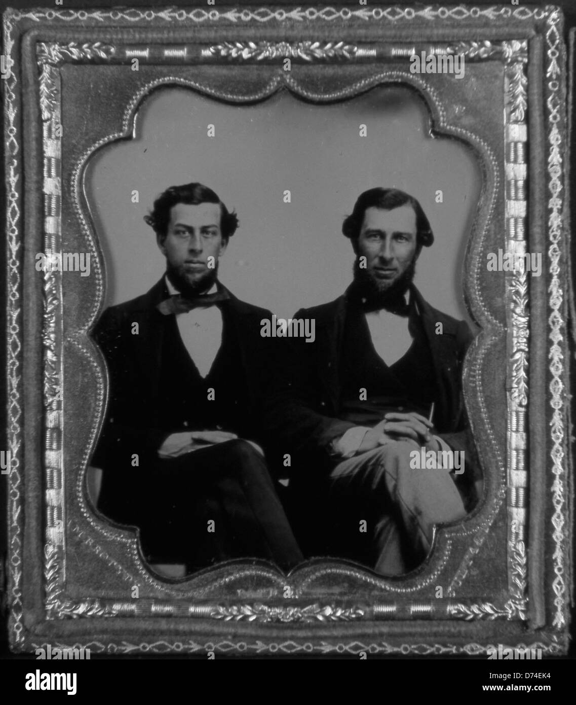 This portrait from 1860 captures two men seated in formal attire ...