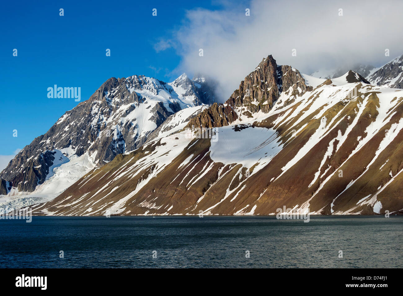 Norway, Hornsund, Glacier heading down from mountain range into ocean ...