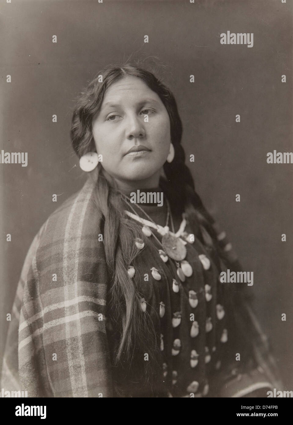 This portrait showcases a Native American woman adorned with beads, a ...