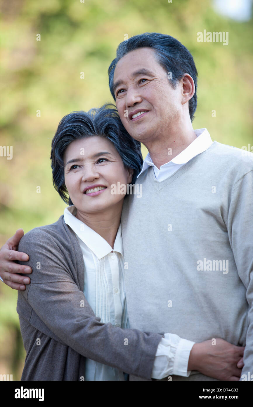 middle aged couple in each other's arm smiling Stock Photo - Alamy