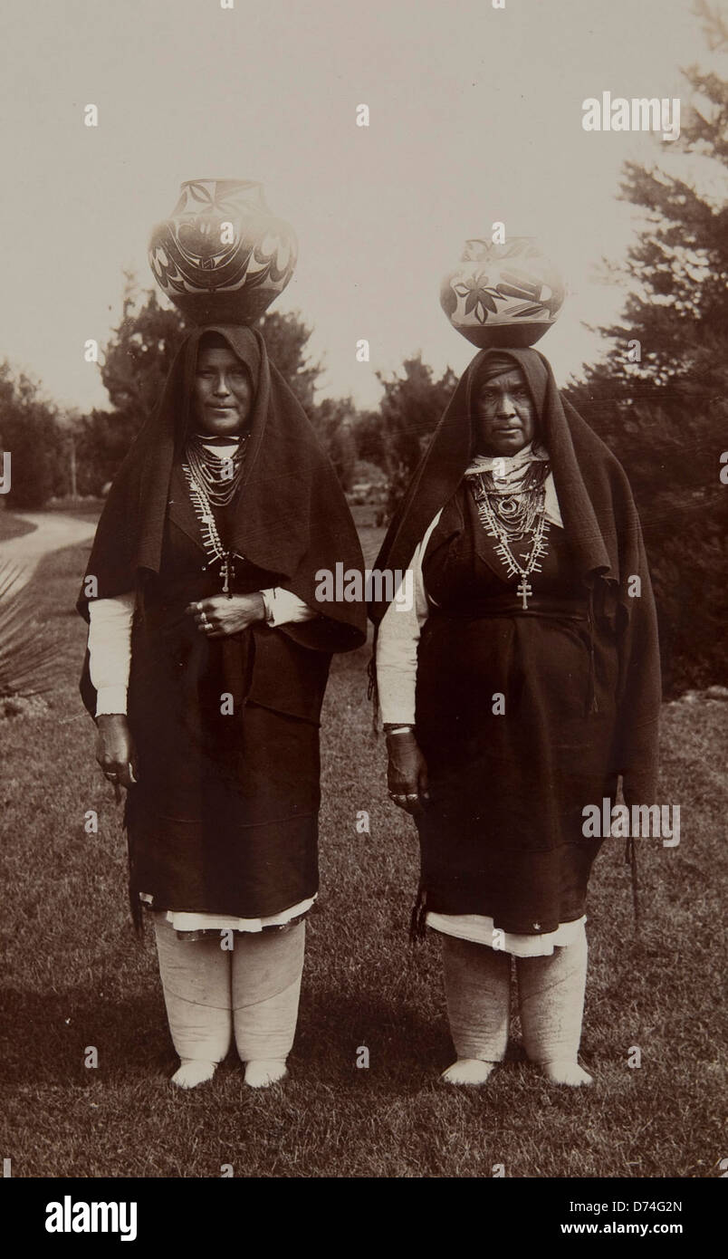 A photograph of two water carriers from Isleta Pueblo, New Mexico ...