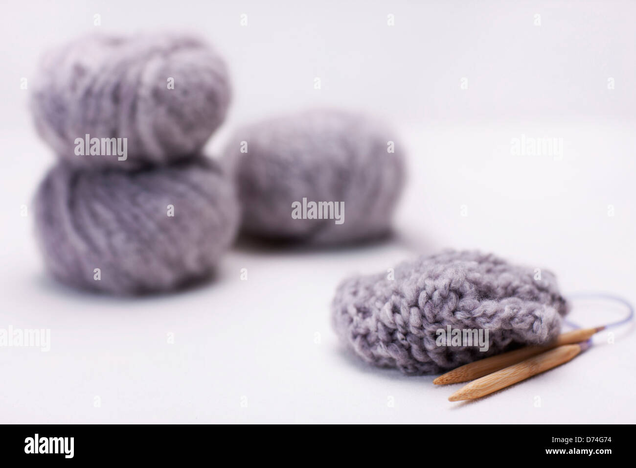 grey yarn and stitch stick in white background Stock Photo - Alamy